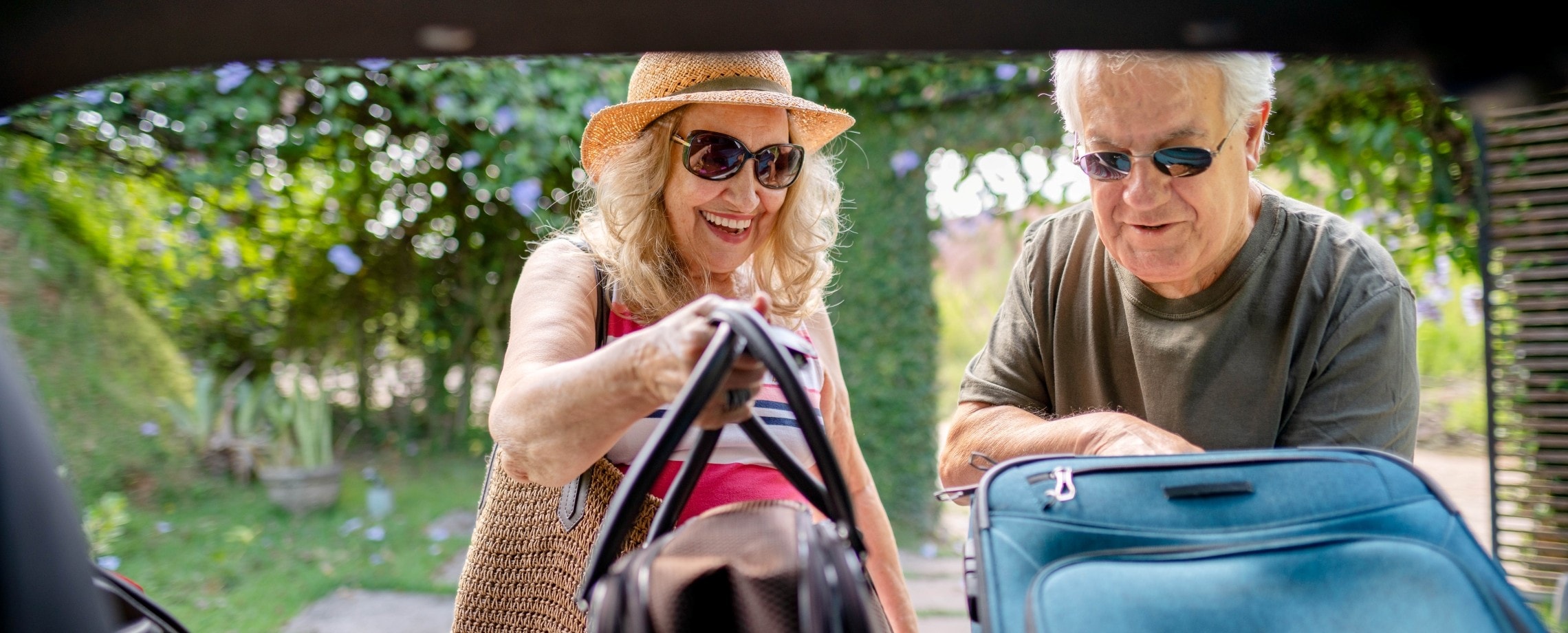 Senior couple packing for a road trip.